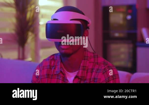 Portrait of african american handsome man gamer removing VR headset ...