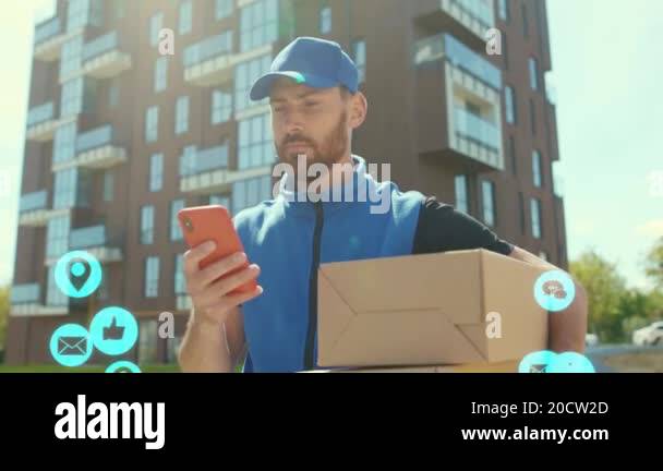 Young handsome young man delivery walking texting message on smartphone ...