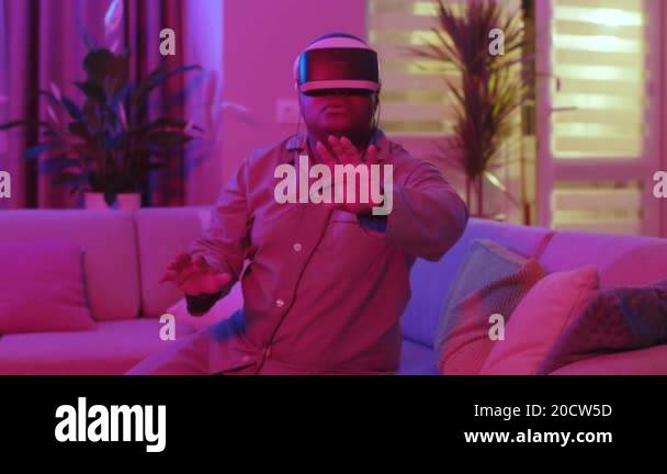 Portrait serious mixed race young man wearing virtual reality headset ...