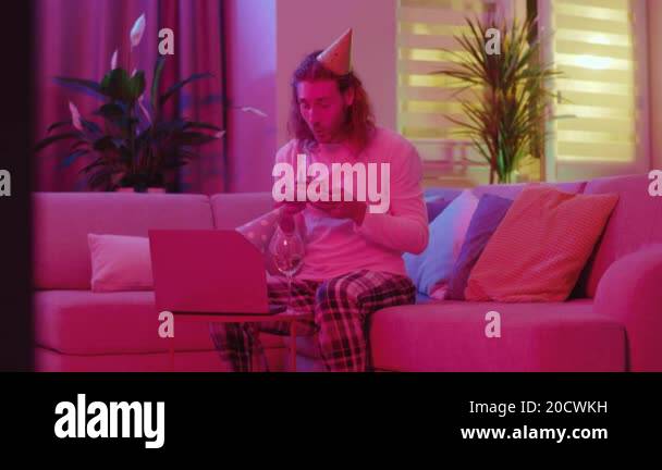 Long haired young hipster man congratulating girlfriend online ...