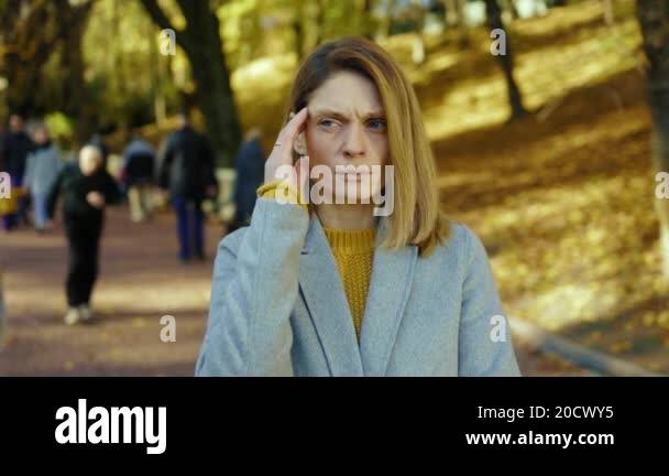 Beautiful face sick young woman with blue eyes having headache feel ...