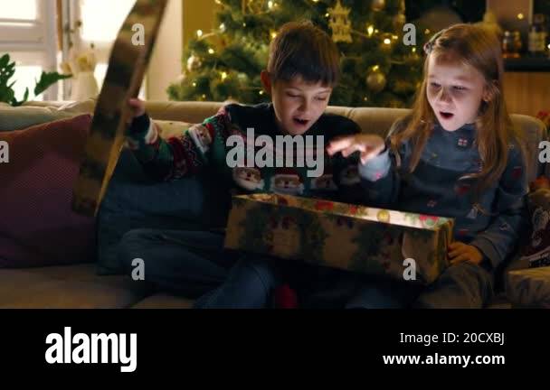 Amazing two kids brother and sister unpacking gifts opening large ...