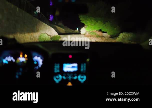 Close up of view from car moving in city with blurred night lights ...