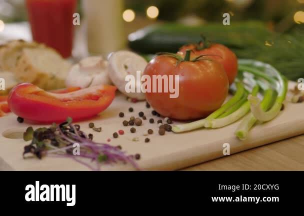 On tablet vegetables on a wooden board. Tomato onion pepper microgreen ...