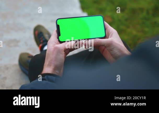Shot of over the shoulder shot of man hands use phone with horizontal ...