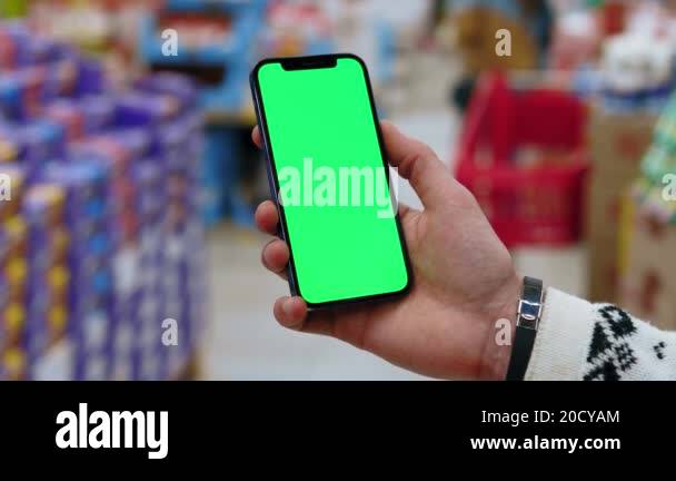 Hands man use mobile smartphone with vertical green screen in ...