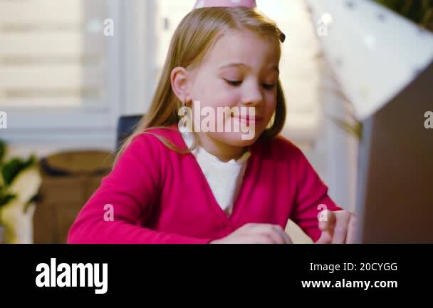 Portrait birthday girl in party hat celebrates birthday alone with ...