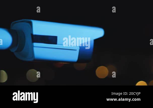 Close up side of security video camera surveillance moving to scan the ...