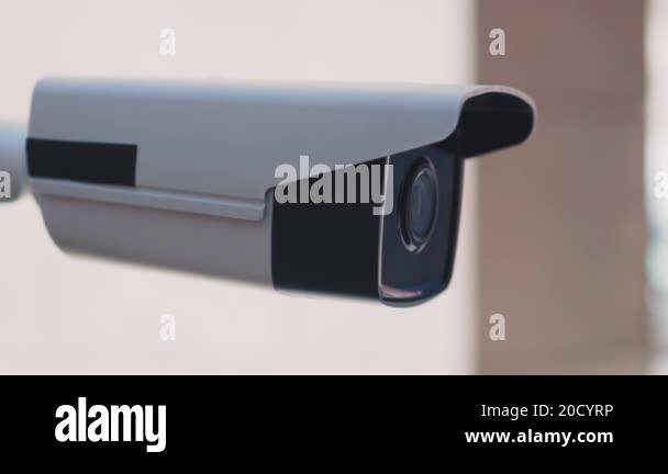 Slow motion security camera moving recording outside a building. CCTV ...