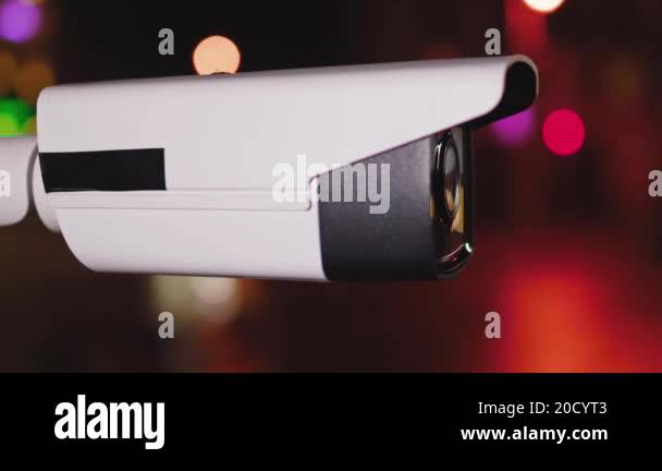 At night security video camera surveillance moving to scan the area ...