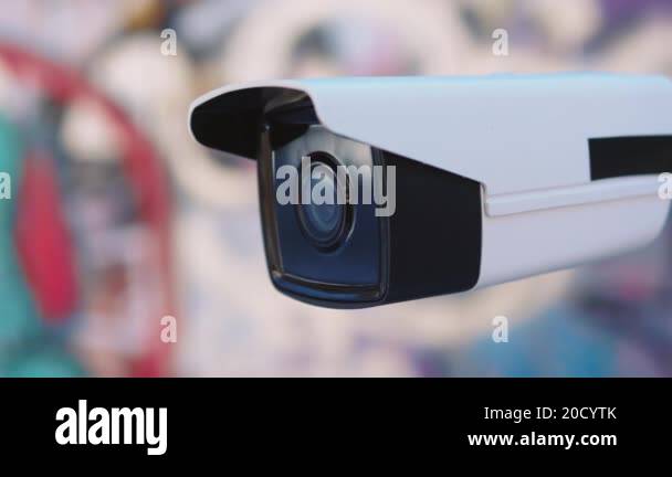 Shot of security camera moving recording outside a building. CCTV ...