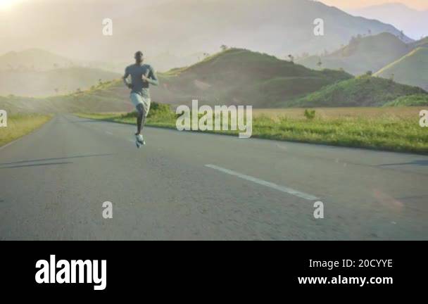 Young African American Man Running at Sunset Background. Mountain View ...