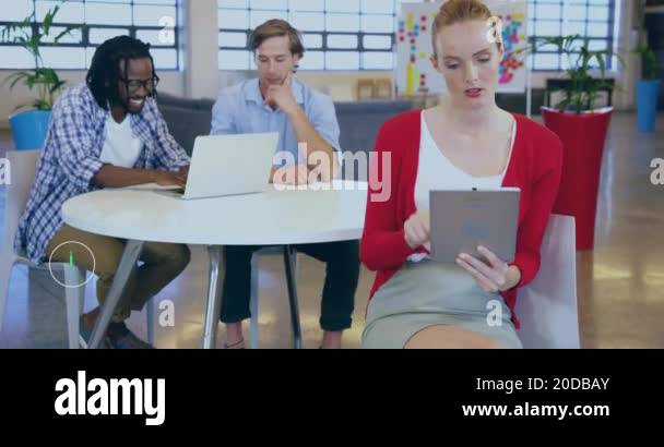 Business icons animation over diverse professionals working with ...