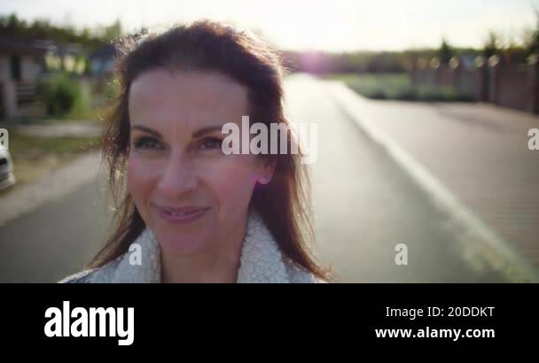 Warm smile on womans face as she gazes upward and opens her eyes to the ...