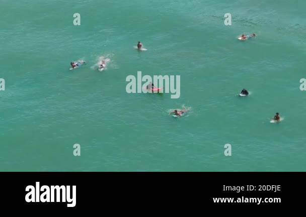 Costa Rica - JULY 12, 2024: Aerial view shows surfers enjoying waves in ...