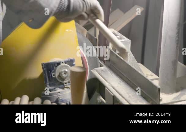 The video shows a woodworking process, where a spinning machine smooths ...