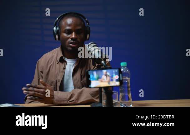 African-American influencer engages with his audience, recording a vlog ...