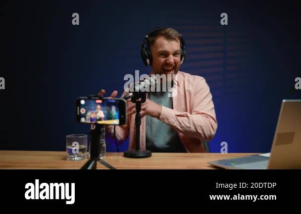 Energetic blogger records a lively video blog showcasing and promoting ...