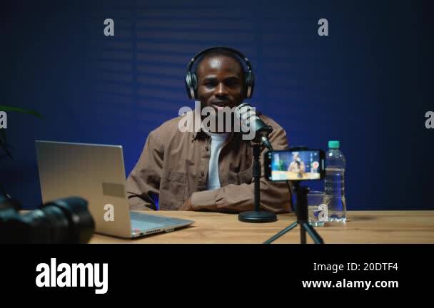 A confident African-American blogger records a new vlog in a ...