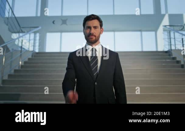 Smiling ceo pointing finger to camera on corporate office stairs. Happy ...