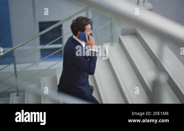 Calling manager going upstairs modern light building with briefcase ...