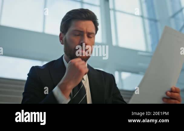 Serious ceo analyzing document dissatisfied information at office ...