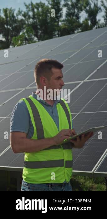 Male Technician Setting Up Solar Panels Through Smartphone Control ...