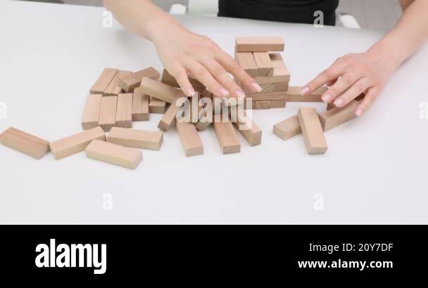 Building a tower of wooden blocks. Play strategy by moving wooden ...