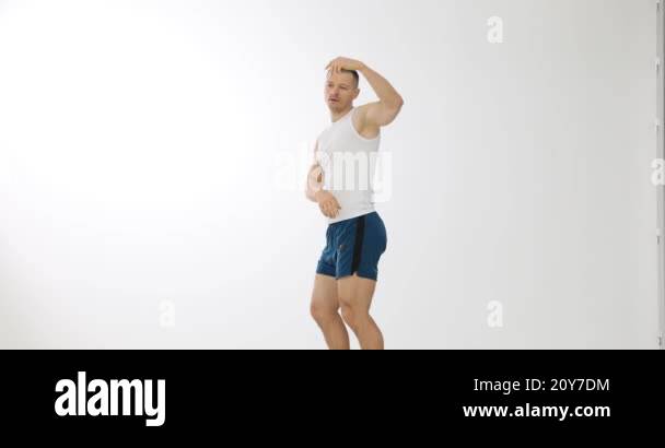 Man performing energetic smooth dance in white studio. Athletic man ...