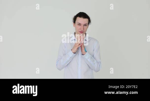 Man showing sign language and looking slyly at camera on white ...