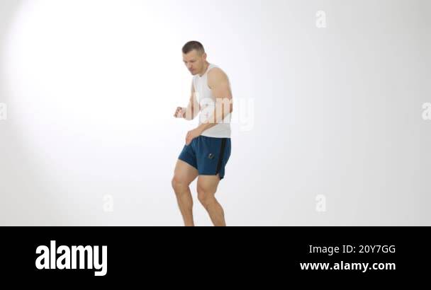 Man performs dance exercises in a fitness studio. Guy dances and ...