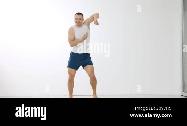 Fitness instructor demonstrates dance moves on white background ...