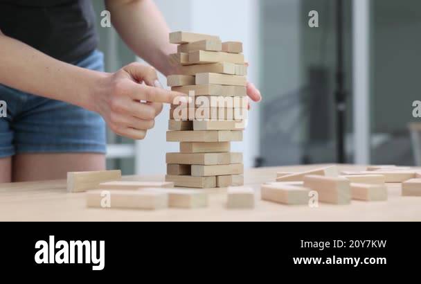 Stacking wooden blocks in a challenging balance game in a modern ...