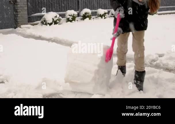 Children playing with snow in winter on a snowy day. Selective focus ...