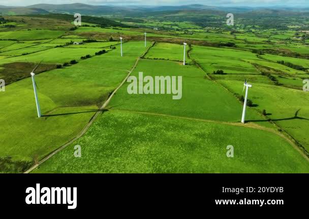 Aerial view of windmills farm for energy production on beautiful green ...