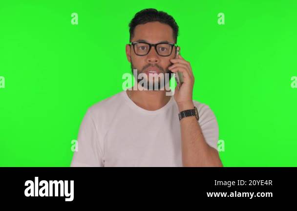 Angry Man Talking on Phone on Green Background Stock Video Footage - Alamy