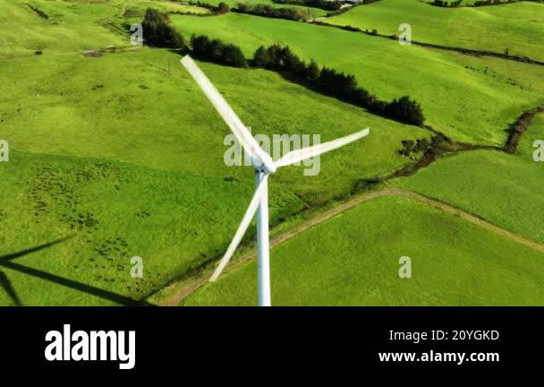 Large wind turbine with blades on green field aerial view of green ...