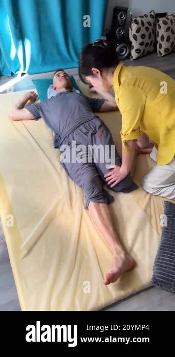 Masseuse making thai yoga massage. Woman therapist doing traditional massage treatment ...