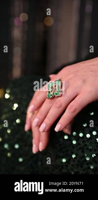 Female hands close up with green flower shaped ring. High quality ...