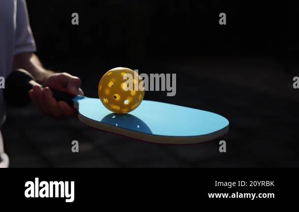 Pickle ball spinning in slow motion on a racket Stock Video Footage - Alamy
