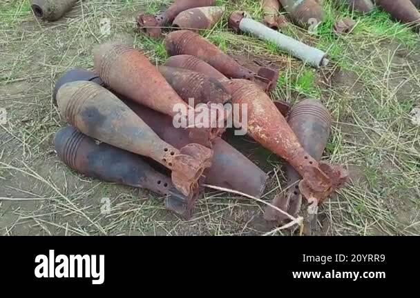 Burnt mortar shells lie on the ground. Mortar shells shattered by the ...