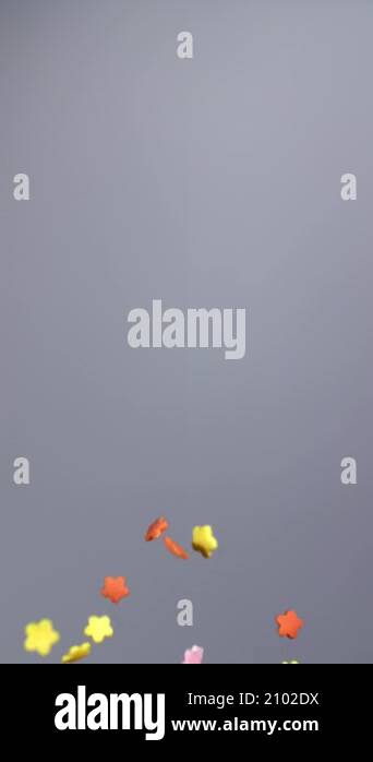 Subtle drift of floral sprinkles gently floating on a soft gray ...