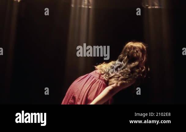 Matrix beams of light illuminate a girl's graceful dance, creating a ...