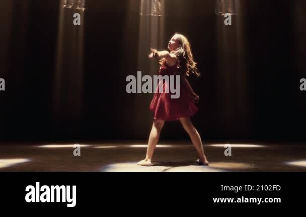 A girl performs a fluid dance surrounded by matrix beams, her movements ...
