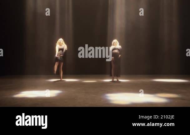 An artistic duo showcases their dance talent under bright studio ...