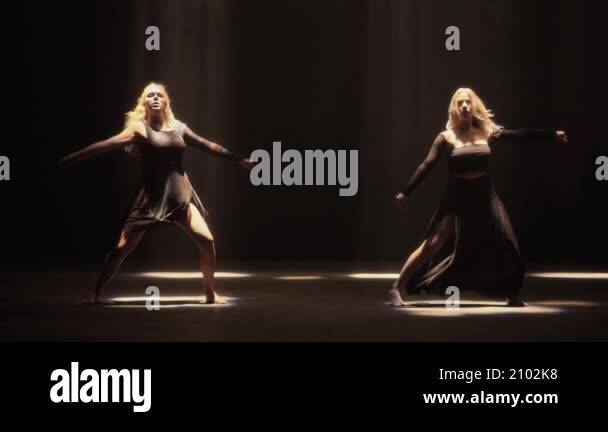 Two young dancers showcase elegant moves under soft studio lights, highlighting their grace and ...