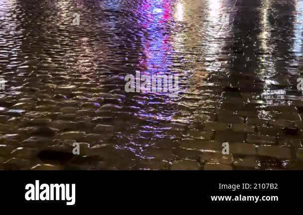 Puddles, streams of water, reflection of light from electric lamps ...