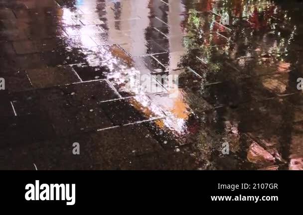 Puddles, streams of water, reflection of light from electric lamps ...