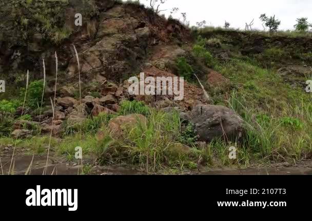 Landslide on a hill with natural background. Rocks scattered on the ...