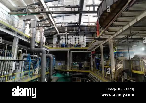 Work premise with equipment operating at production of cardboard. Pipes ...